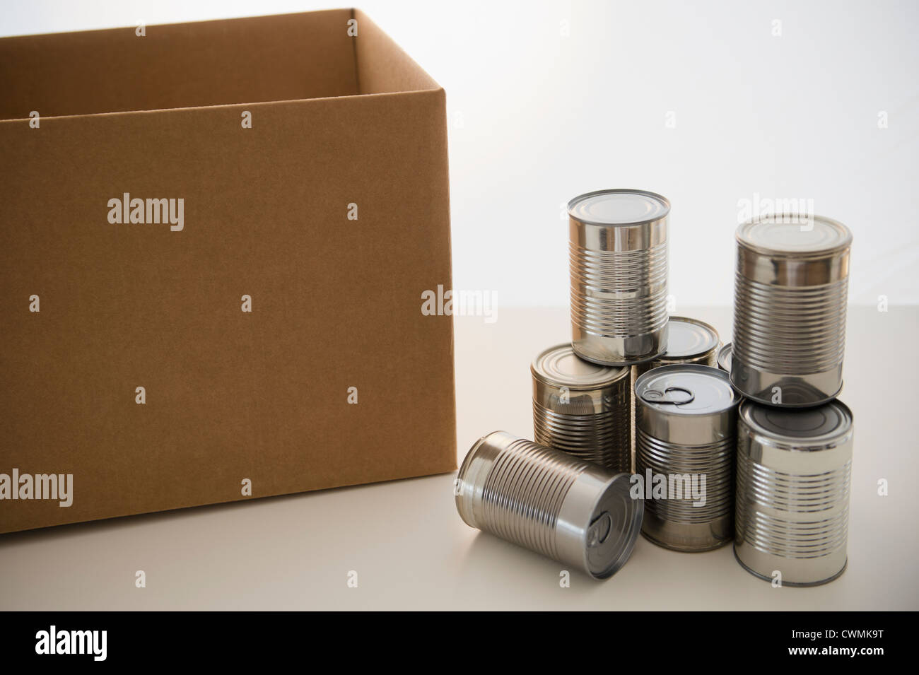 Tin cans and cardboard box Stock Photo - Alamy