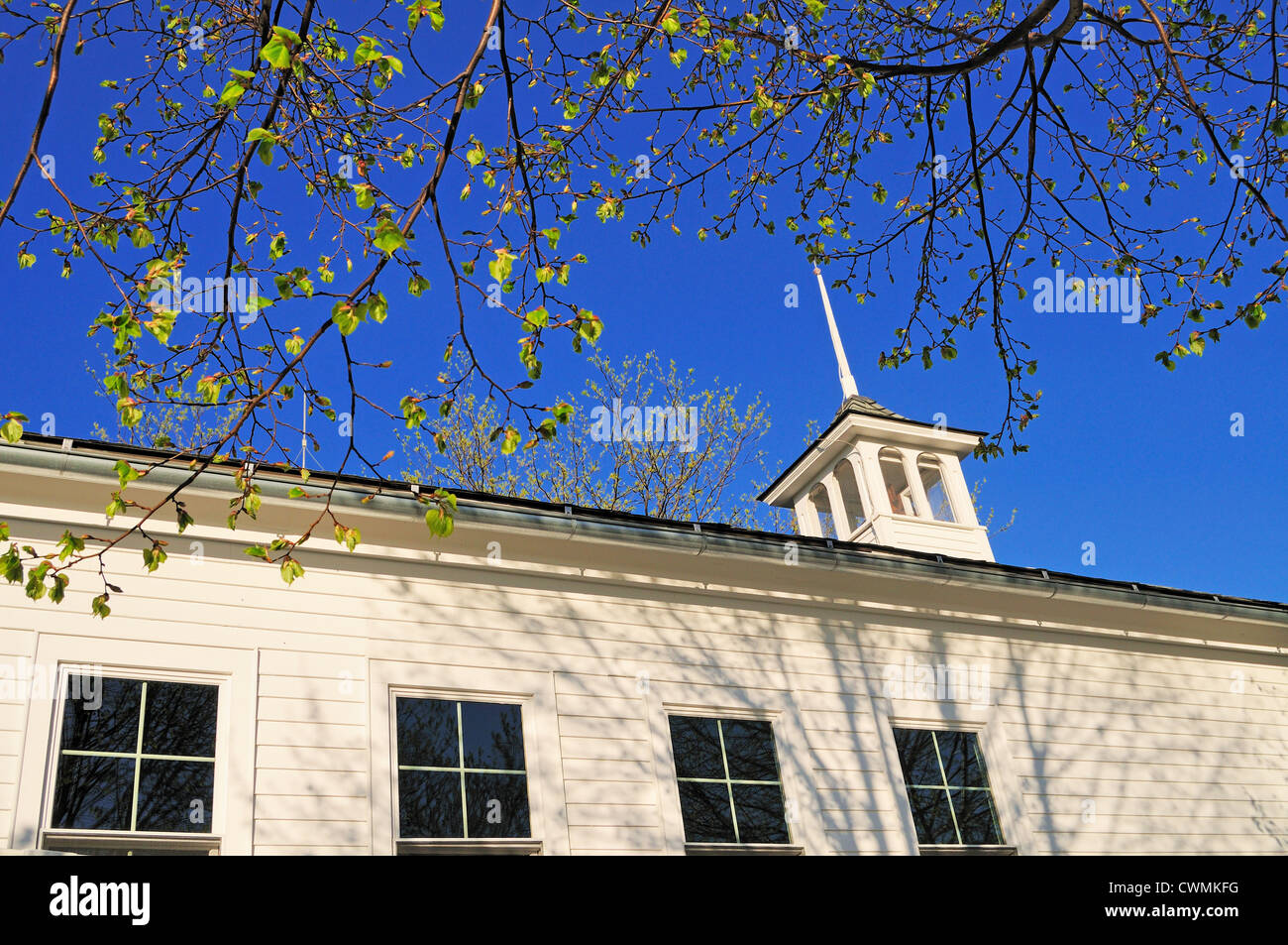 Spring rural school building clapboard siding church-like steeple bell ...
