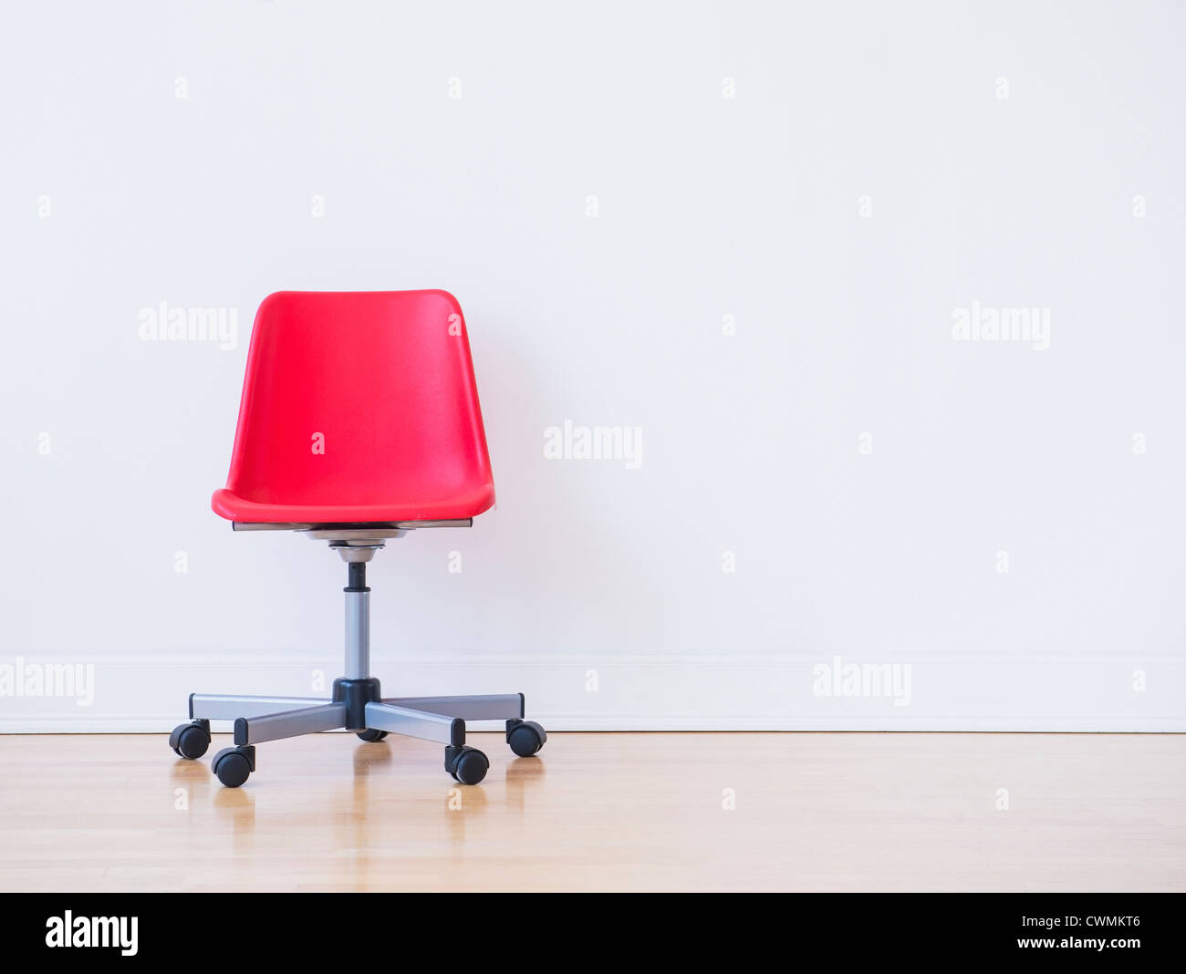 Studio shot of red office chair Stock Photo - Alamy