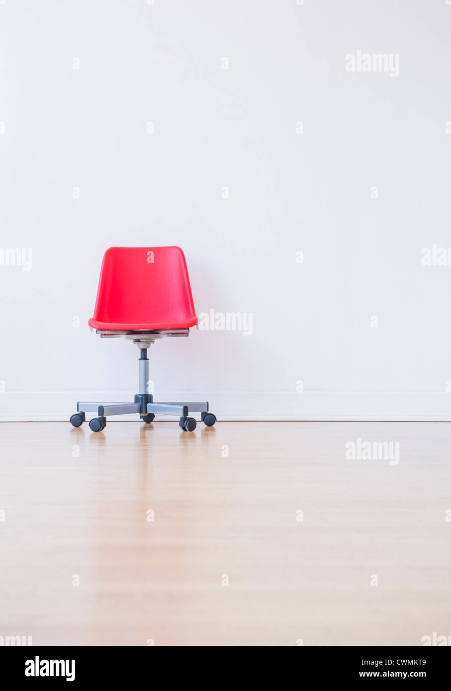 Studio shot of red office chair Stock Photo - Alamy