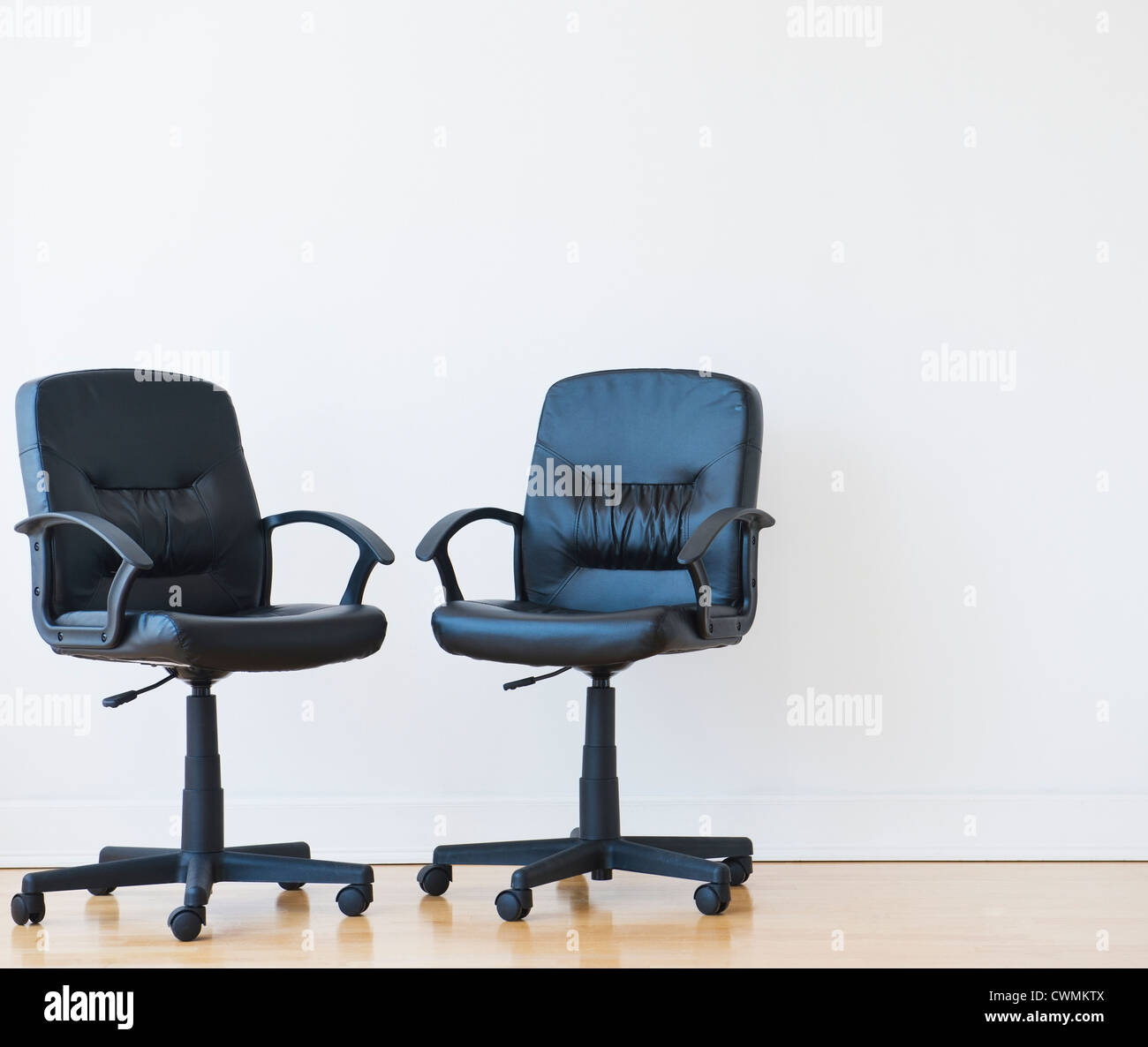 Studio shot of two black office chairs Stock Photo - Alamy