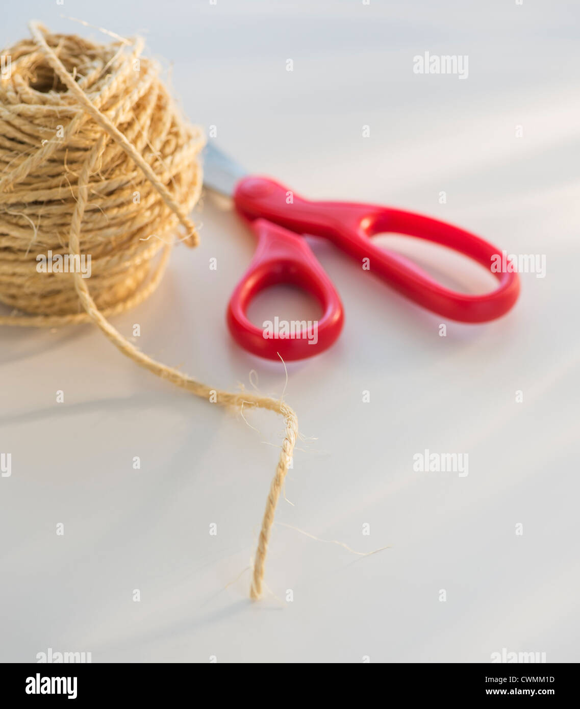 Coiled string and scissors Stock Photo - Alamy