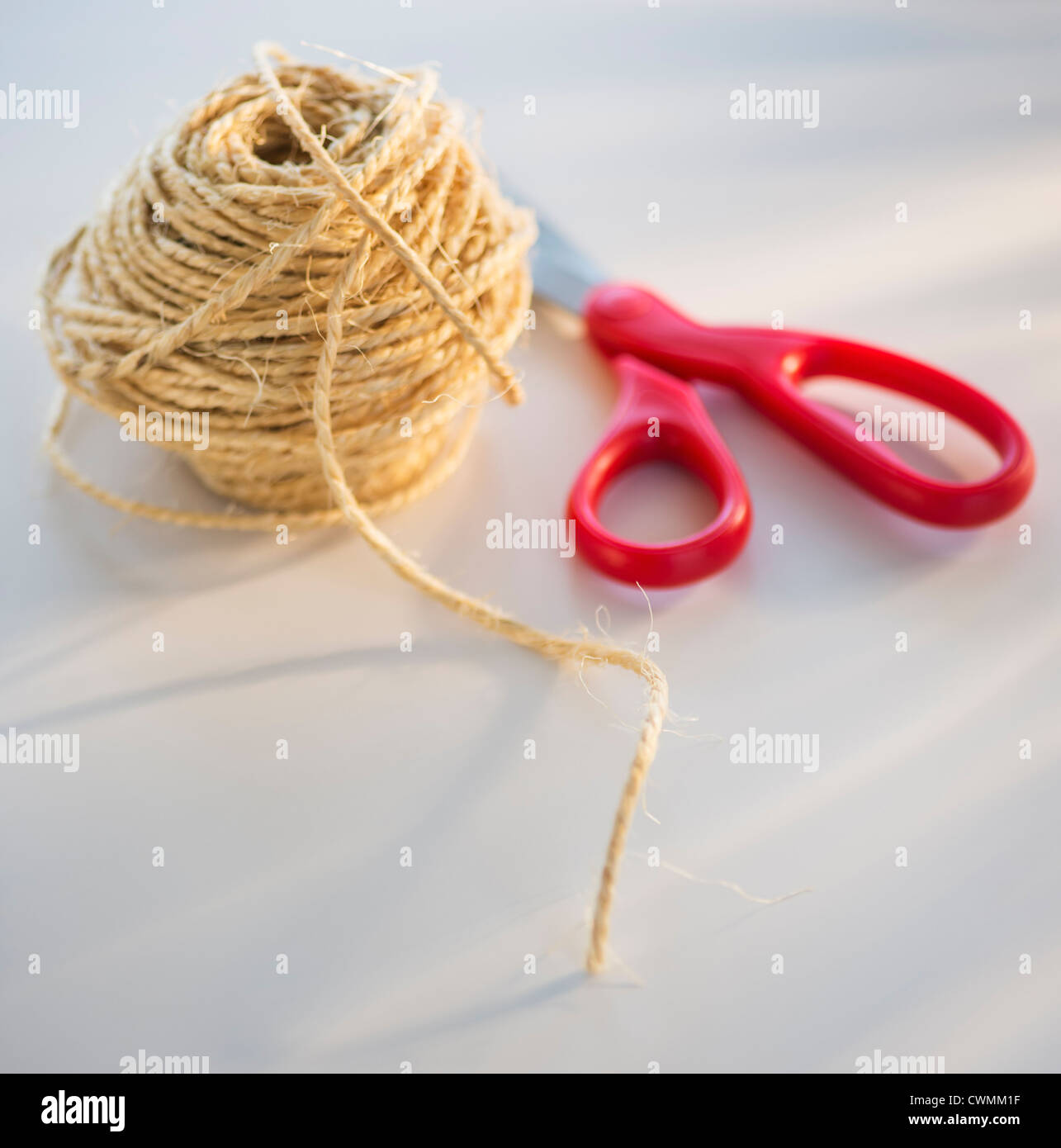 Coiled string and scissors Stock Photo - Alamy