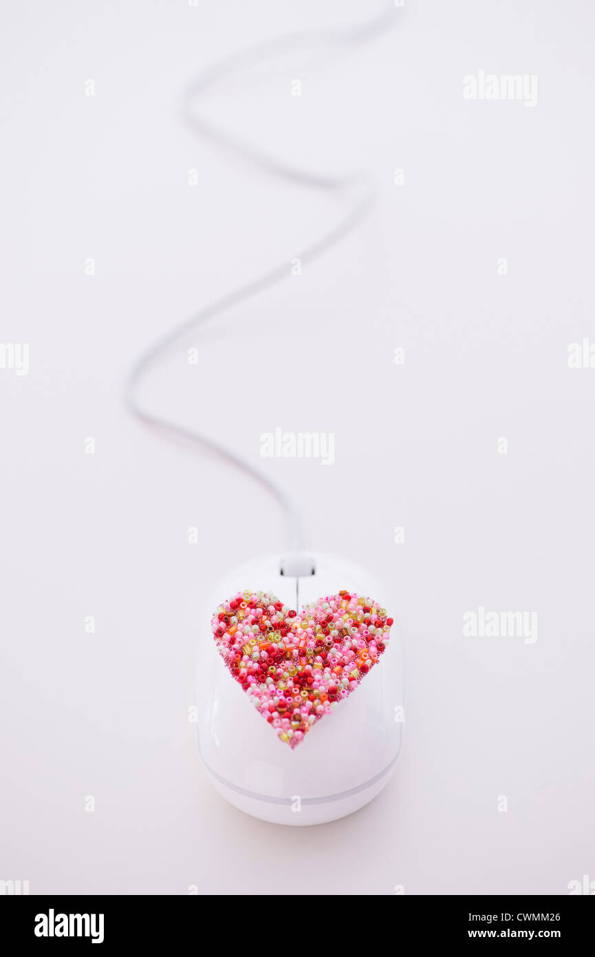 Colorful heart on computer mouse Stock Photo - Alamy