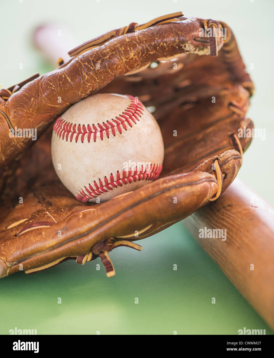 Baseball glove with ball and bat Stock Photo - Alamy