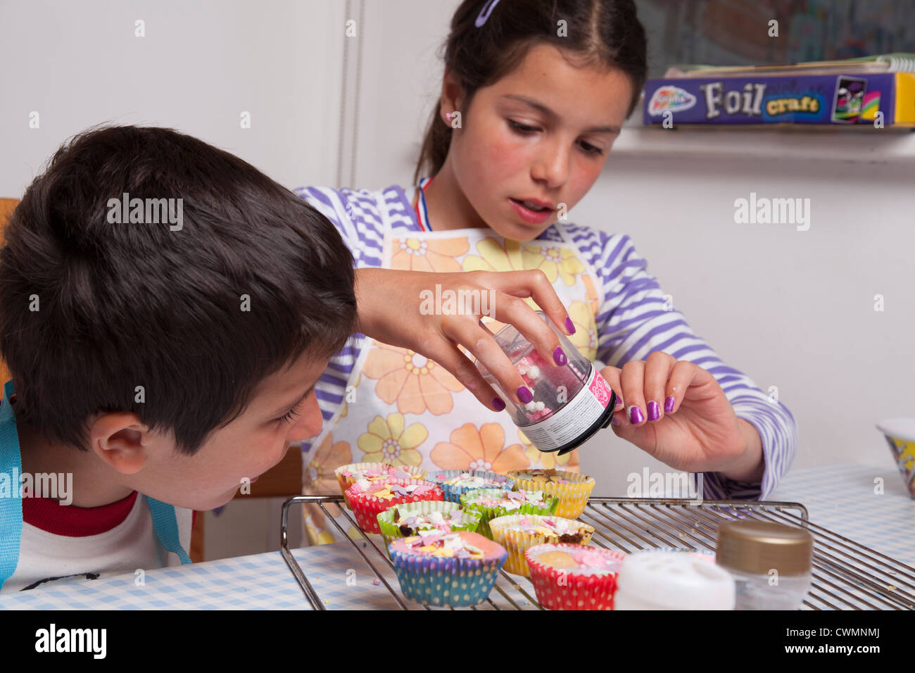 Children decorating cakes together Stock Photo - Alamy