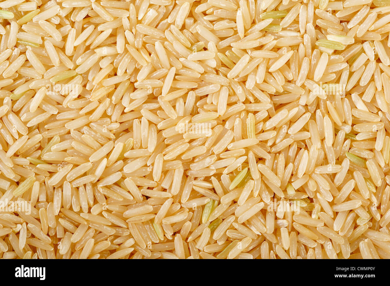 Uncooked Brown rice background Stock Photo - Alamy