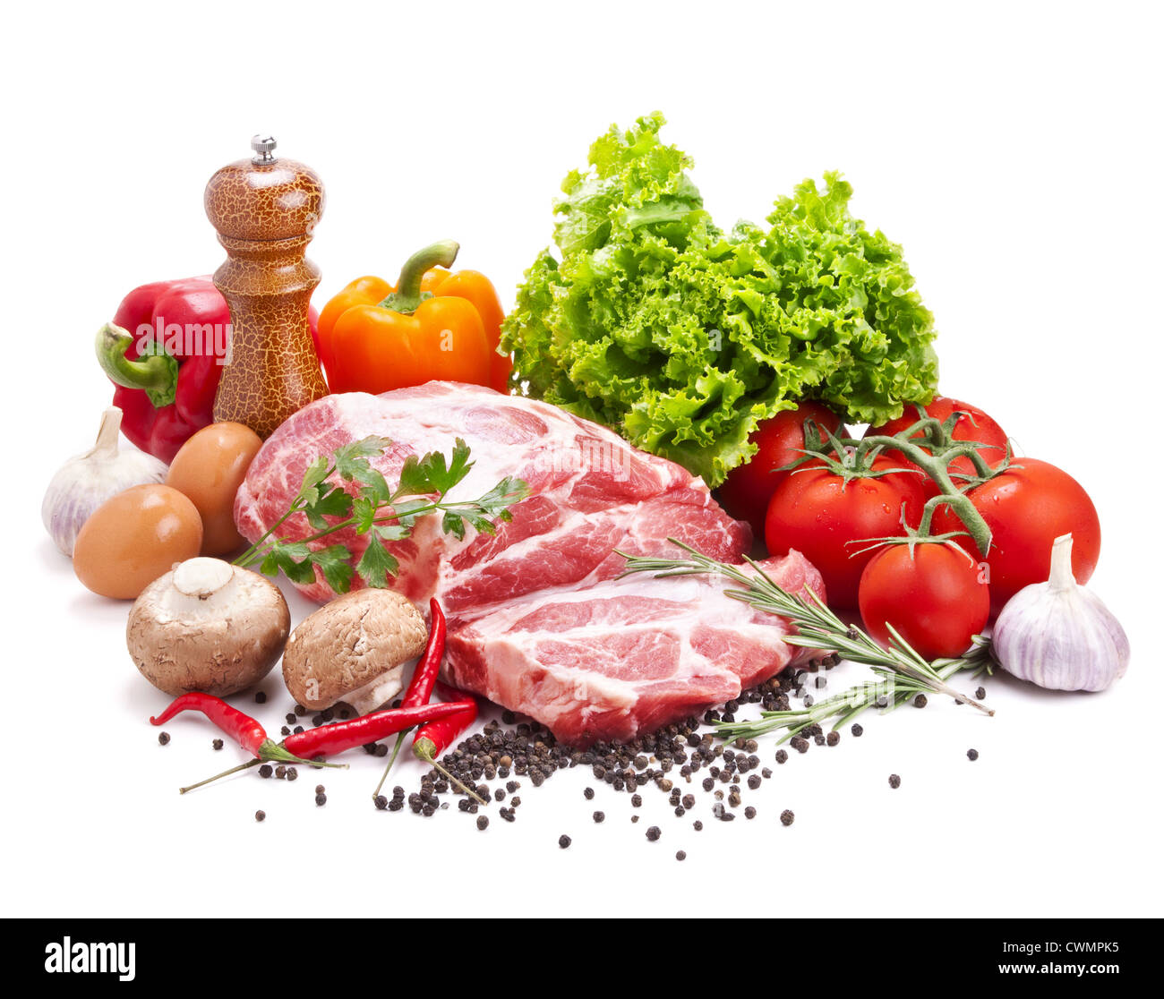 Still life with raw pork meat and fresh vegetables isolated on white ...