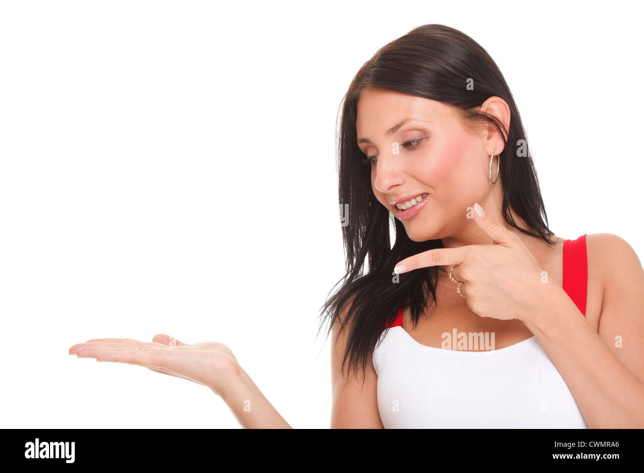 Young woman showing product with open hand palm - excited expression on ...