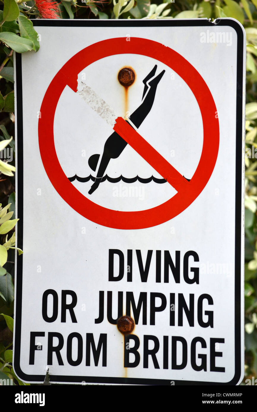 No diving or jumping from bridge sign with the "no" scratched off Stock ...