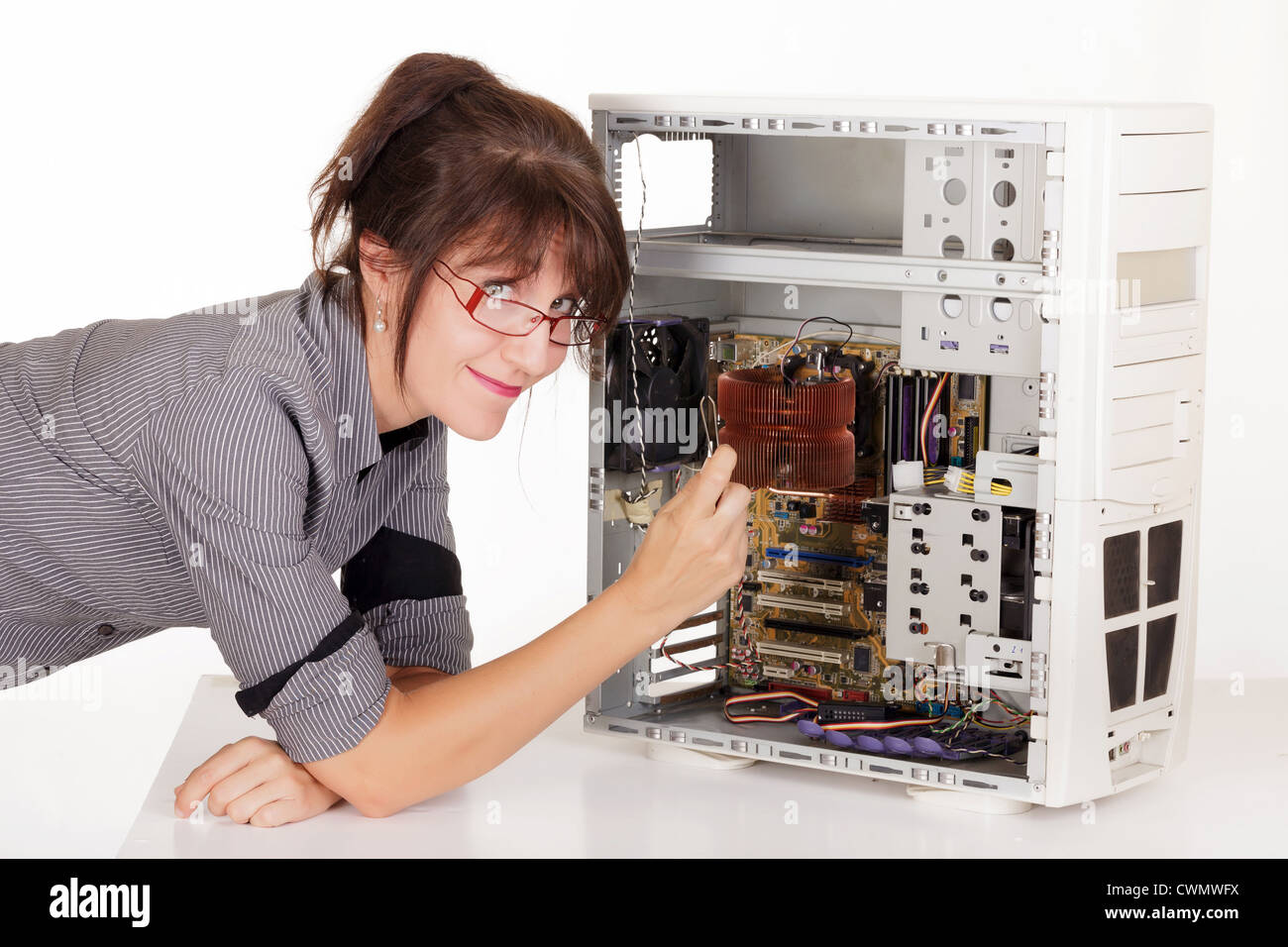 woman trying to repair computer with tweezers Stock Photo - Alamy