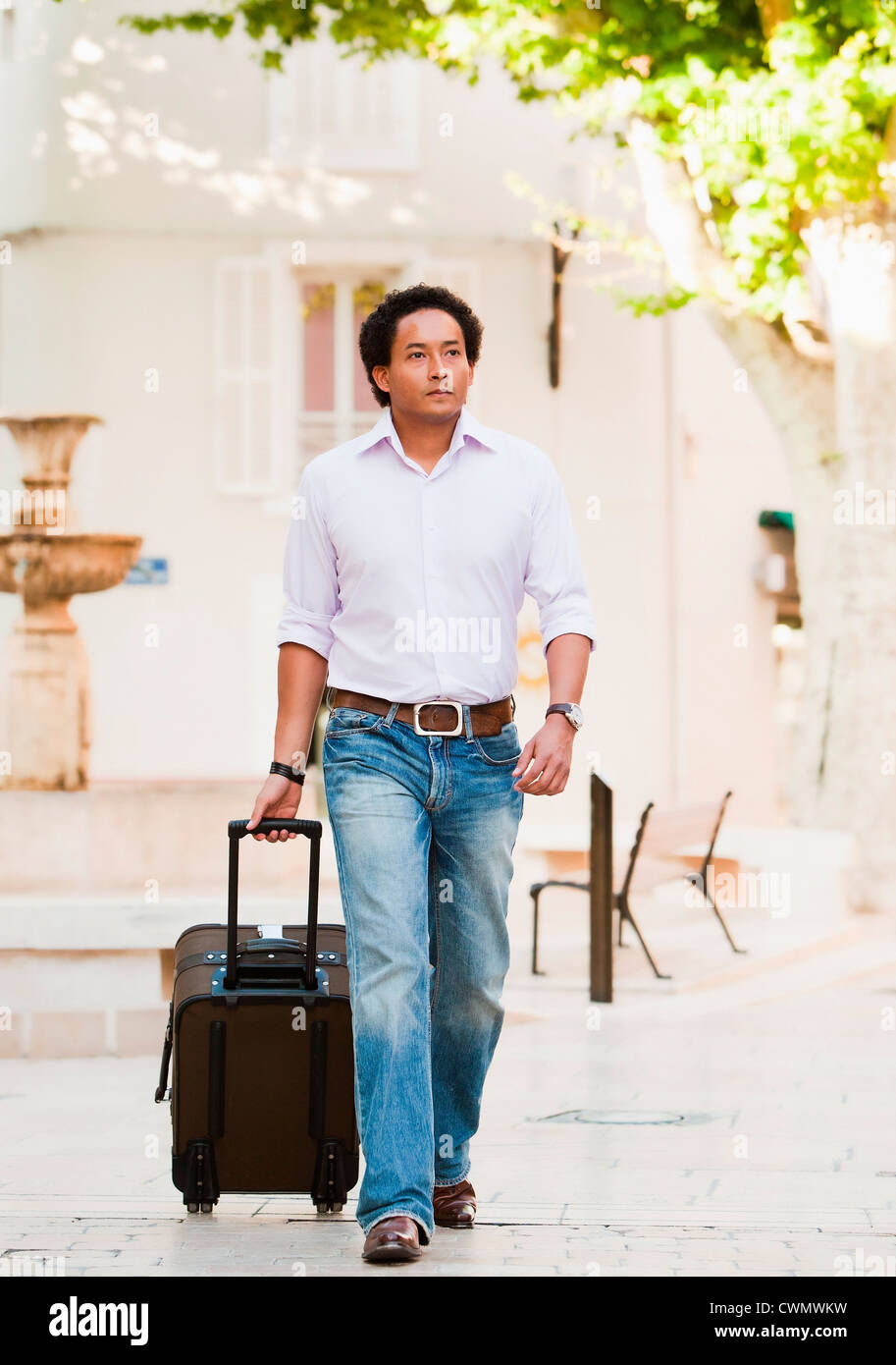 France, Cassis, Man walking with suitcase Stock Photo - Alamy