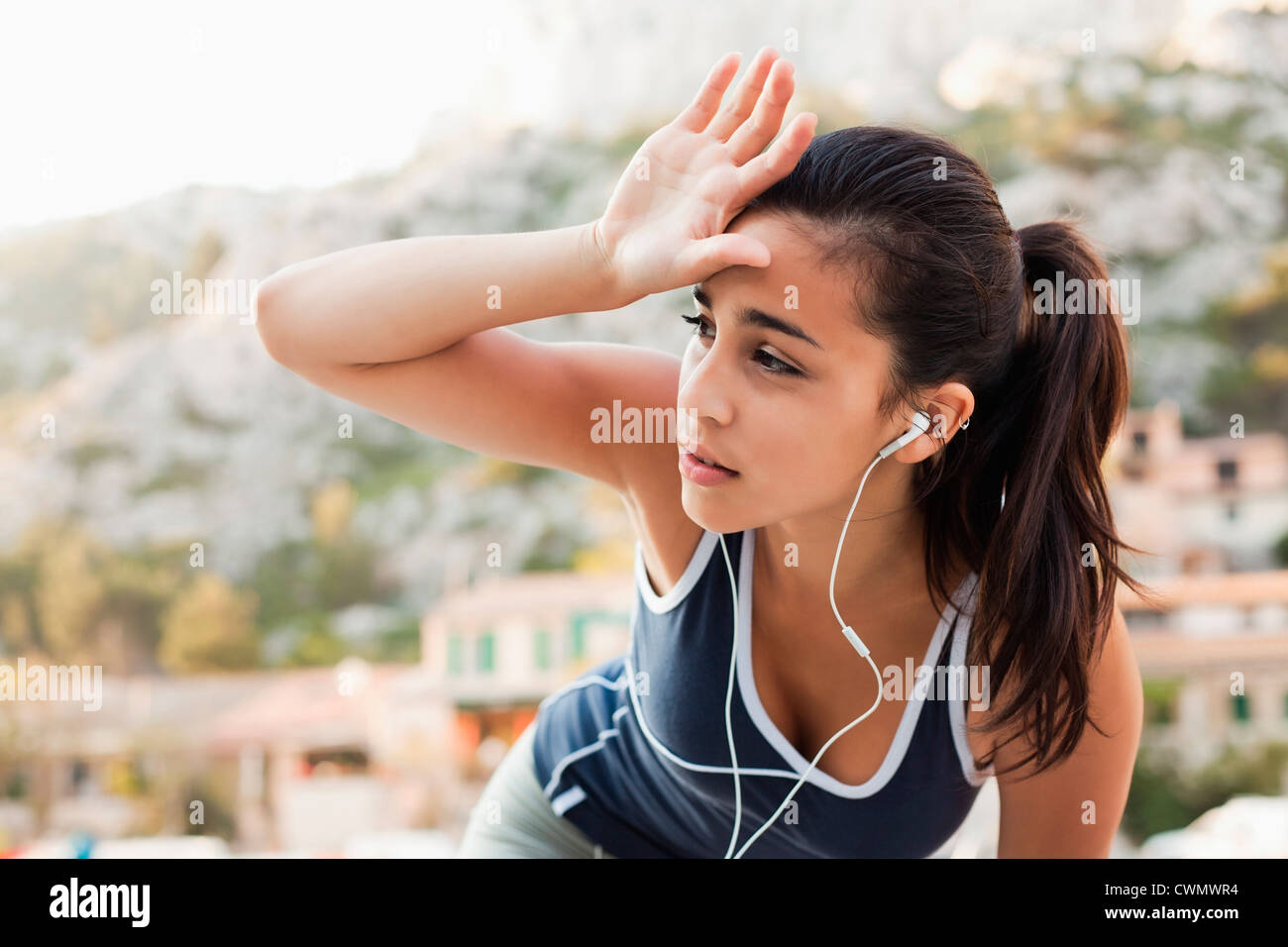 France, Marseille, Young woman in tracksuit and with headphones Stock ...