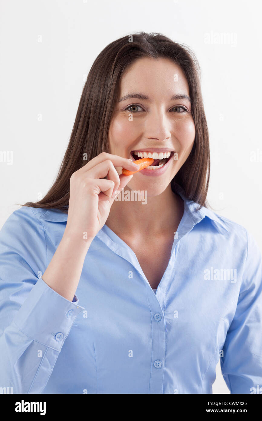 Studio portrait woman eating carrot hi-res stock photography and images ...