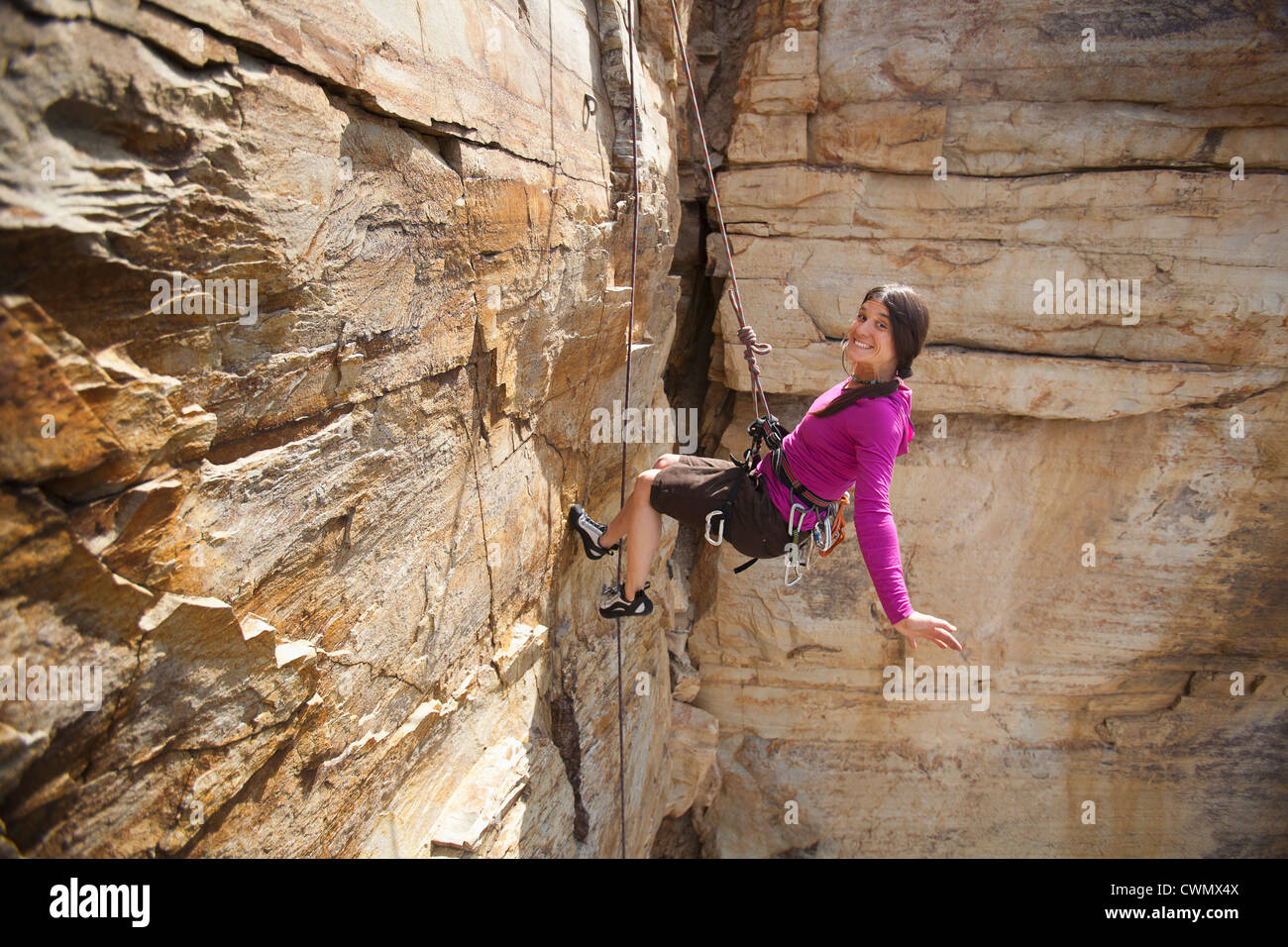 Smiling woman rock climbing Stock Photo - Alamy