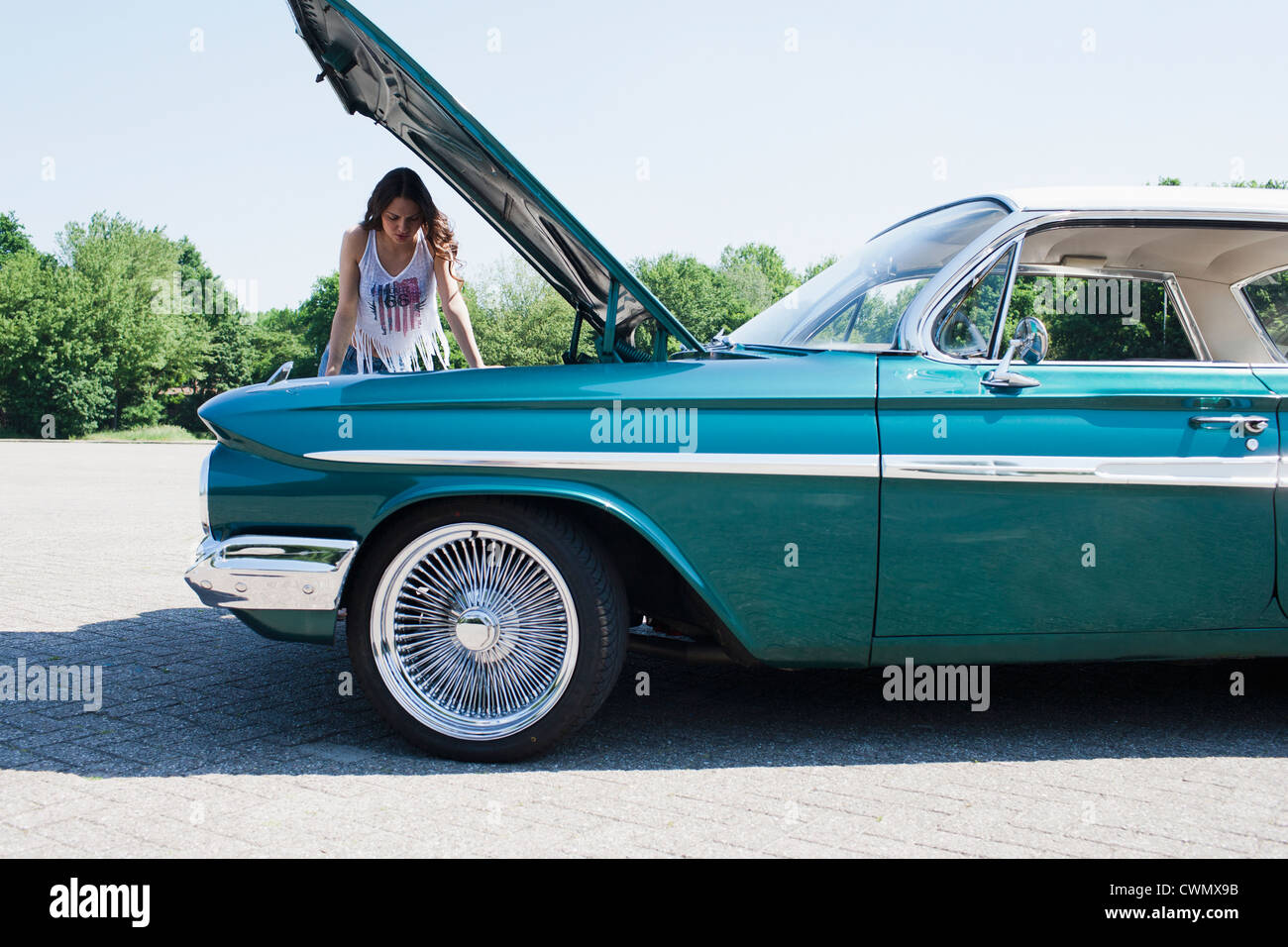 Netherlands, Tilburg, Woman standing near broken vintage car Stock ...