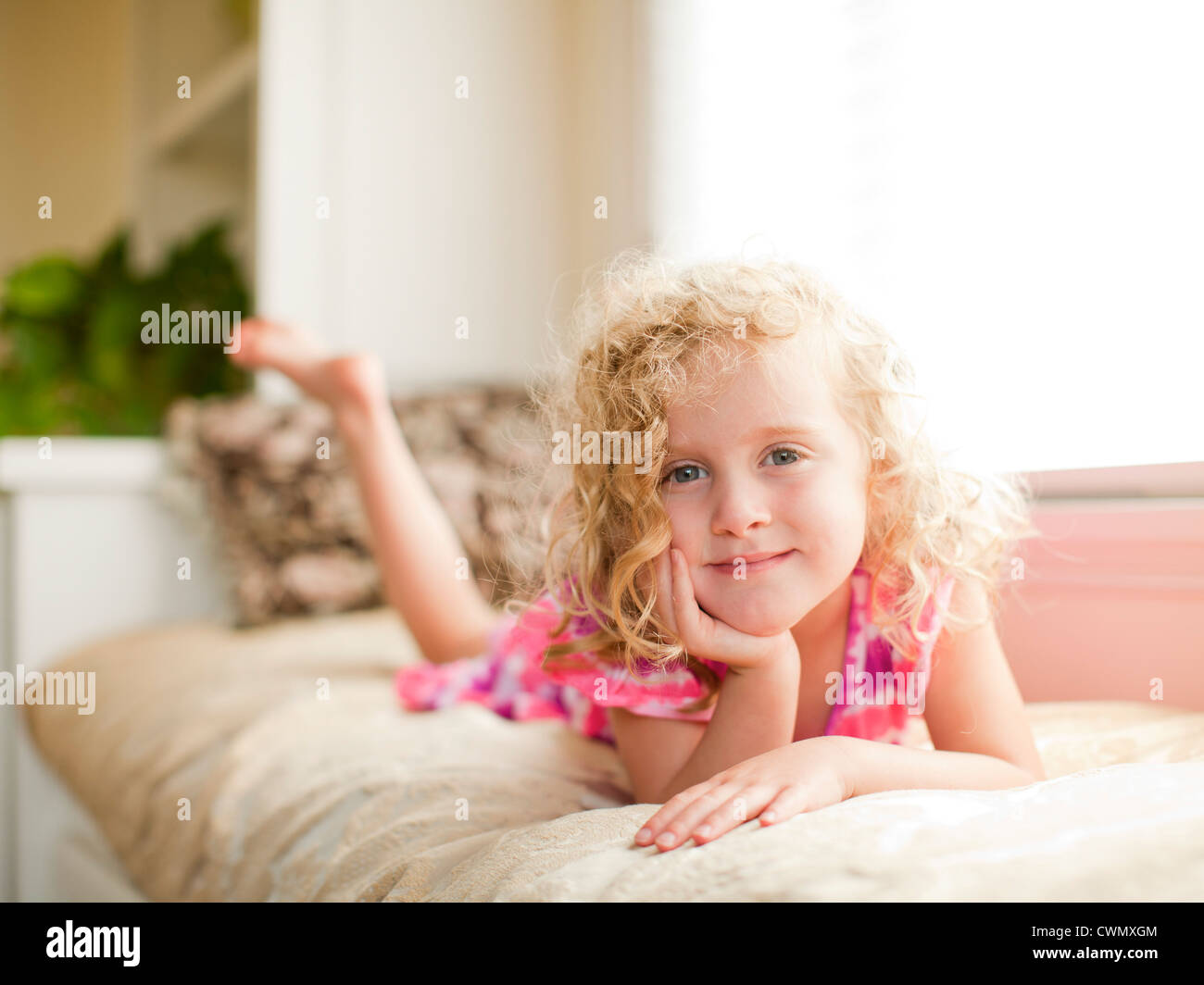 USA, Utah, Salt Lake, Portrait of girl (4-5) lying on bed Stock Photo ...
