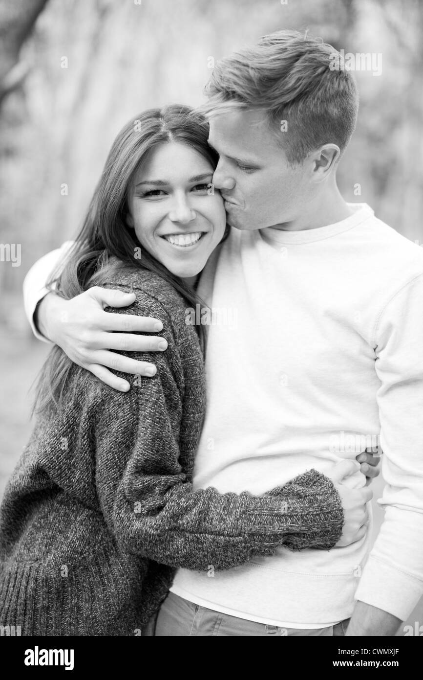 Loving young couple kissing lake hi-res stock photography and images ...