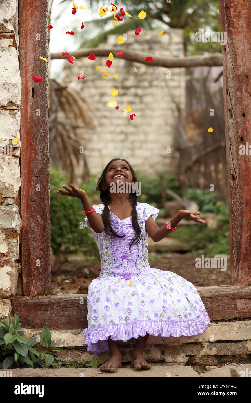 Young Indian rural girl throwing rose petals Andhra Pradesh South India ...