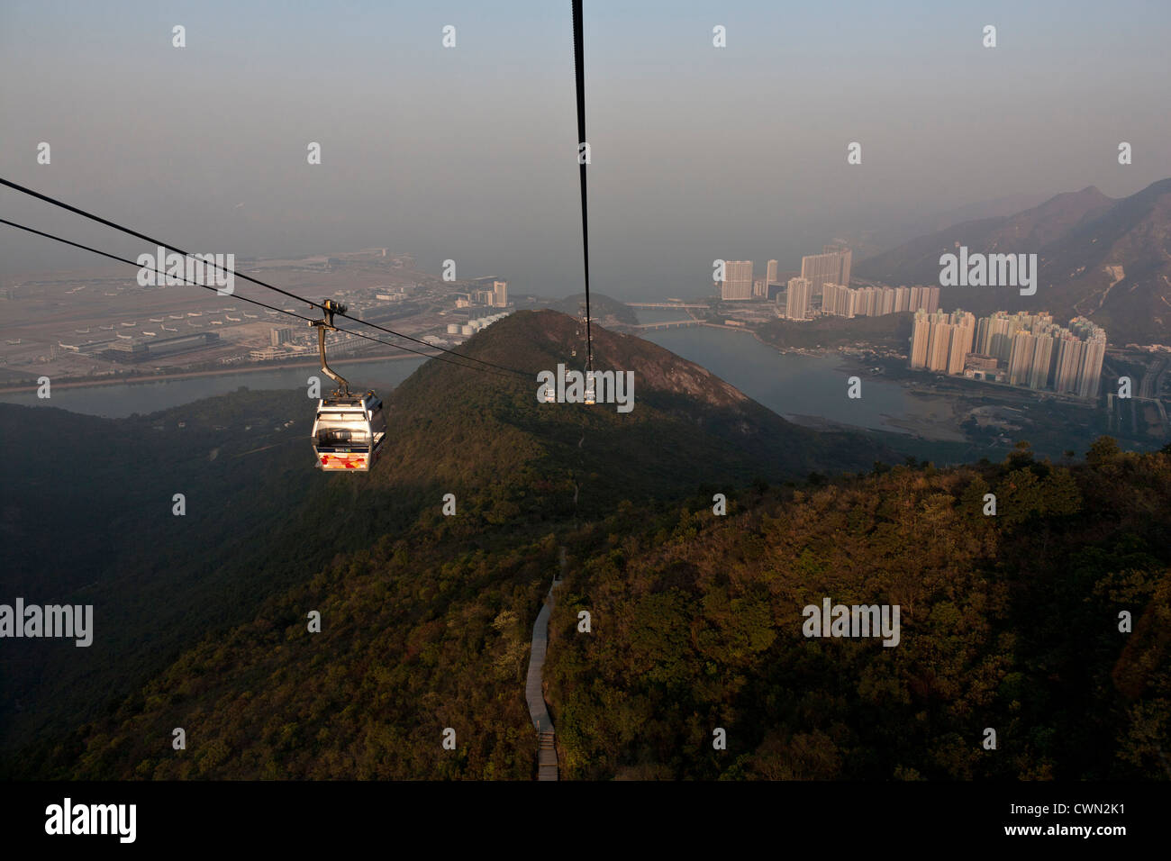 Ngon Ping 360 cable cars descend onto Tung Chung town on Lantau Island ...