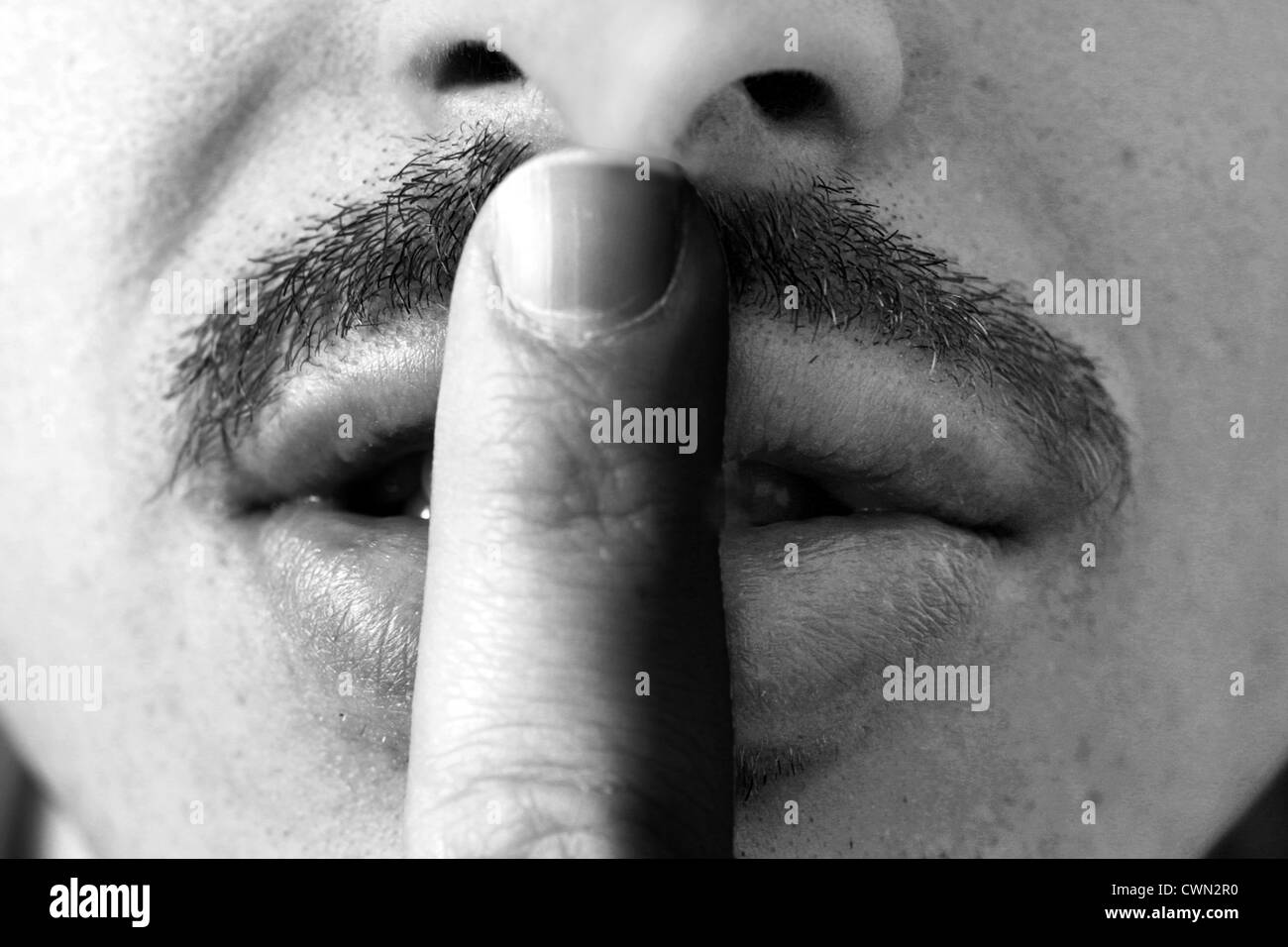 Hush finger mouth Black and White Stock Photos & Images - Alamy