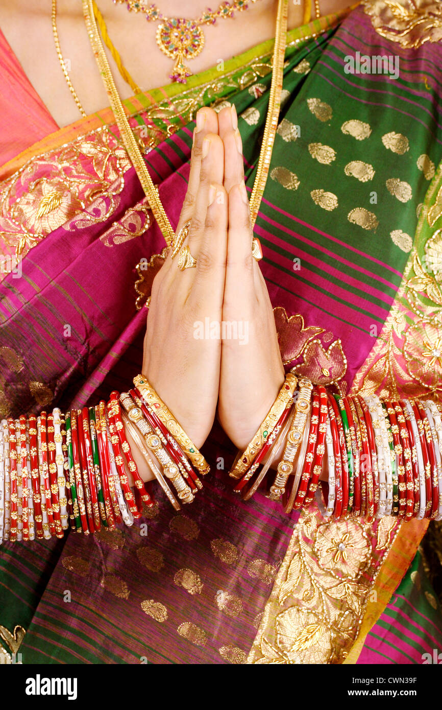 Traditional Indian girl holding hands in prayer position Stock Photo ...