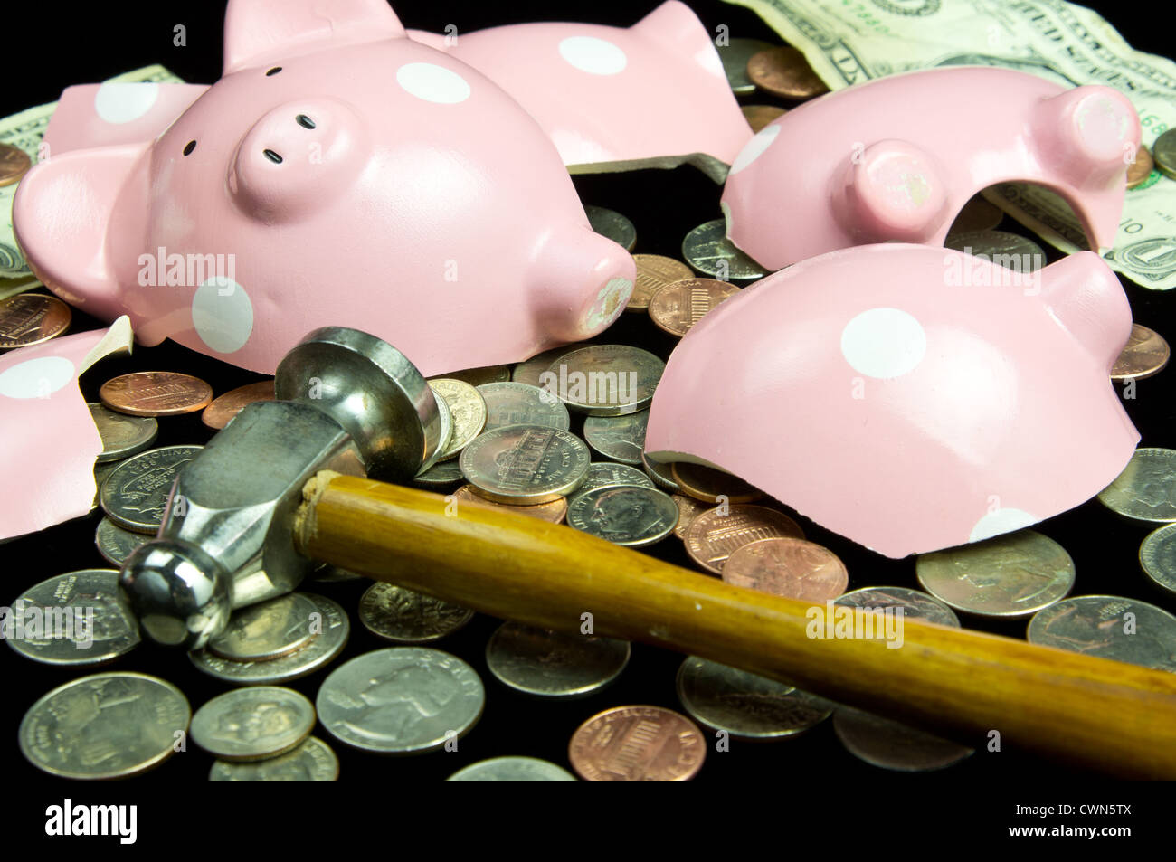 Broken piggy bank with coins broken with hammer Stock Photo - Alamy