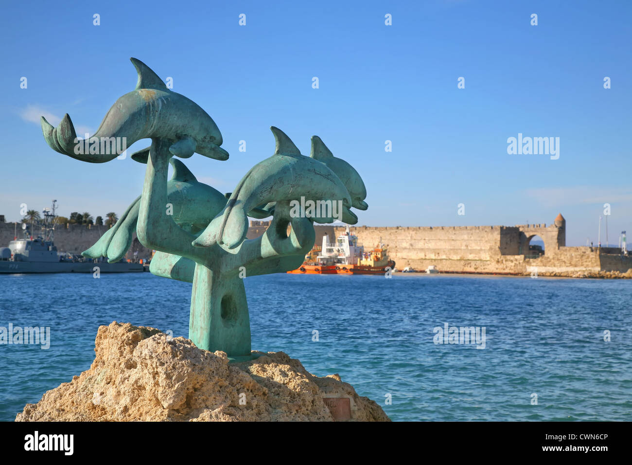 Dolphin statuary overlooking the harbour of Rhodes Stock Photo - Alamy