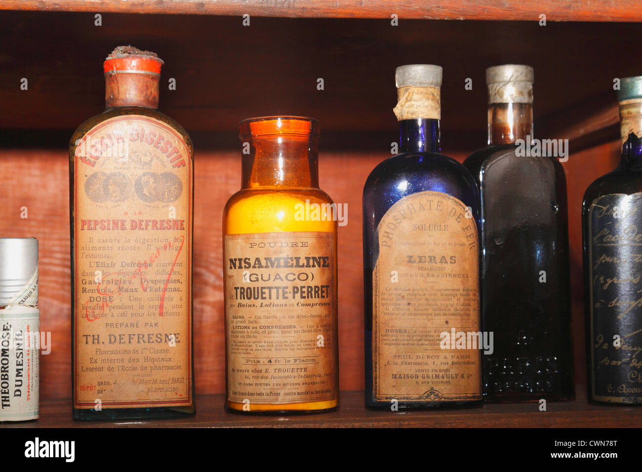 Vintage medical pharmaceutical colorful chemical bottles on the shelf ...