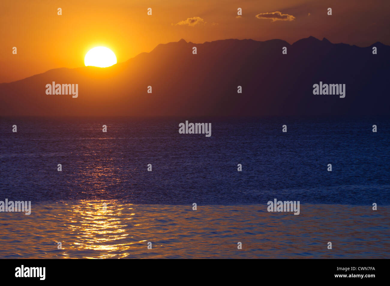 Sun, sea, and mountain during sunset in Manila Bay, Philippines Stock ...