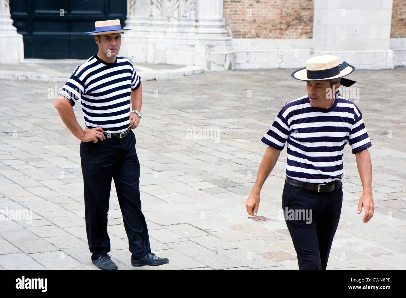 Gondoliers dressed in traditional clothes having a conversation in ...