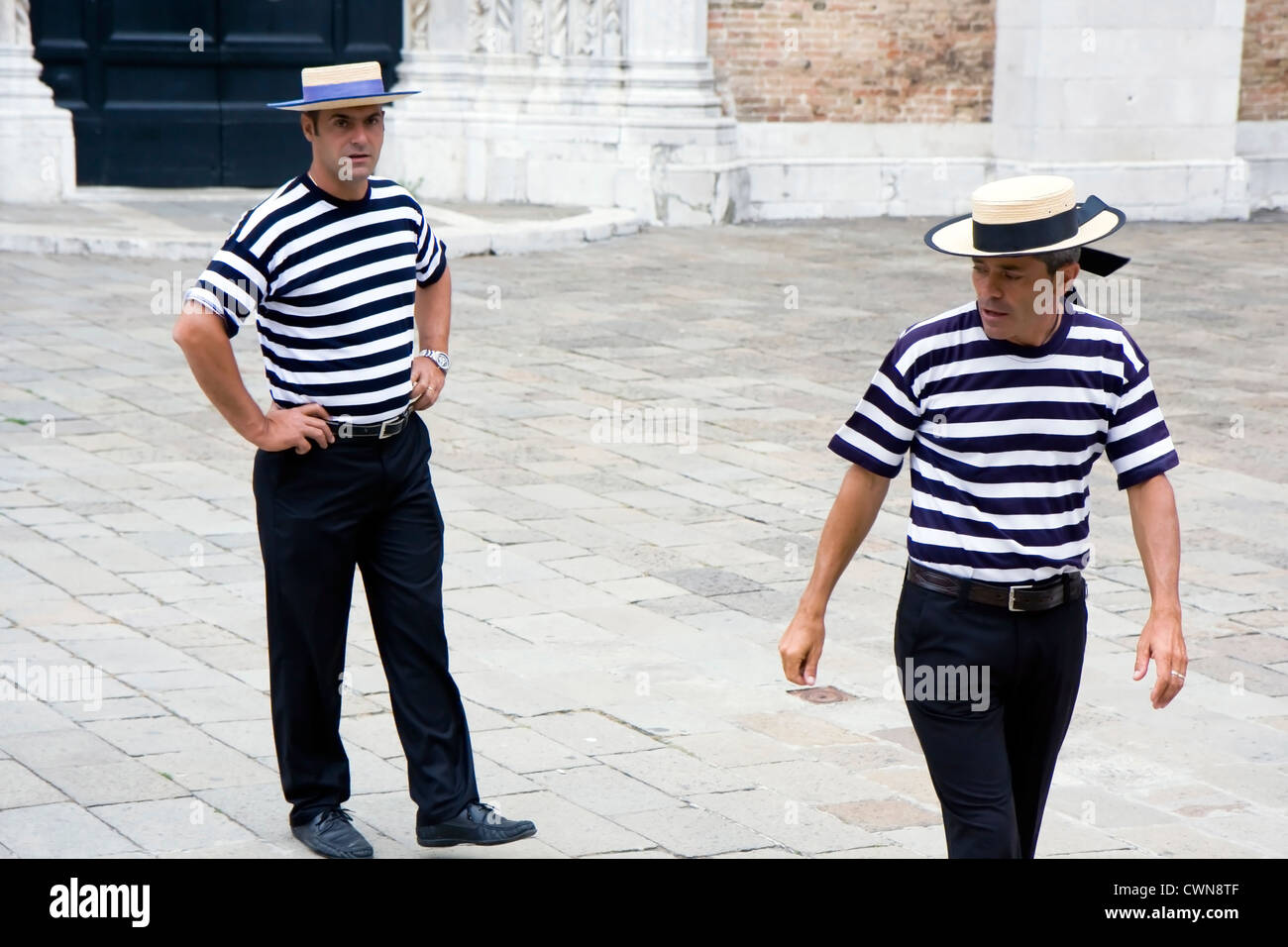 Gondoliers dressed in traditional clothes having a conversation in ...