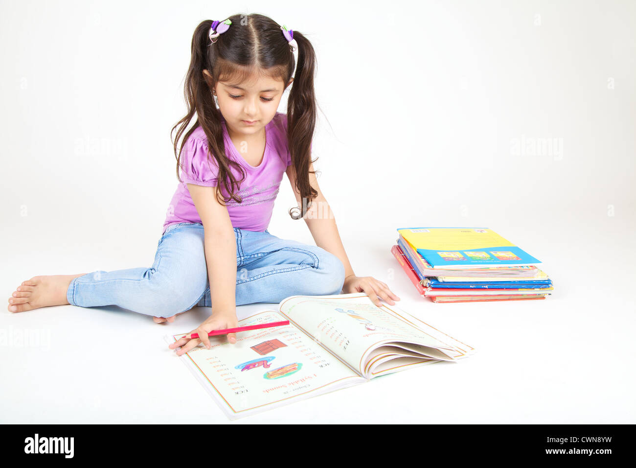A young girl reads a book Stock Photo - Alamy
