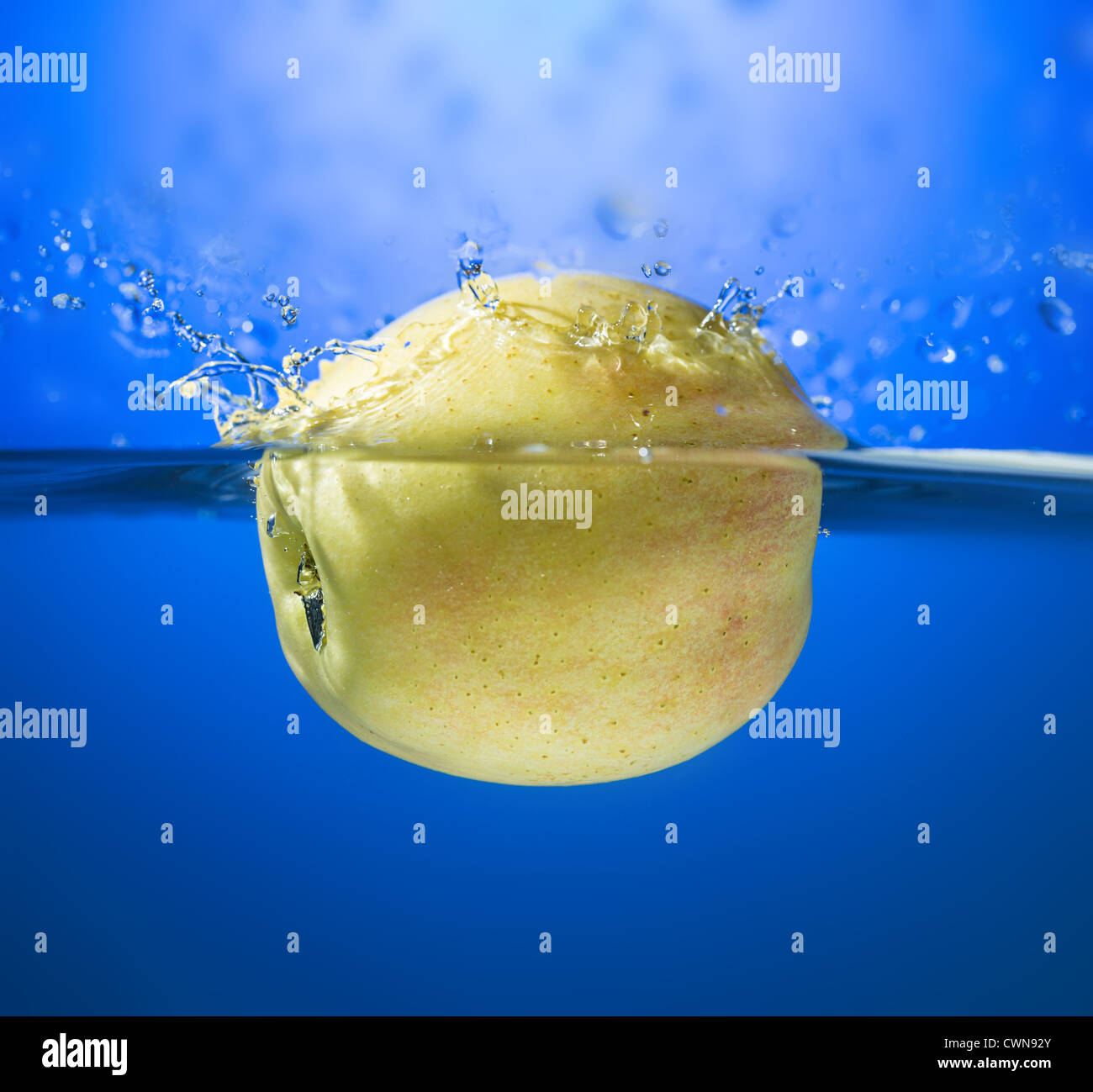 Yellow apple in water splash Stock Photo - Alamy