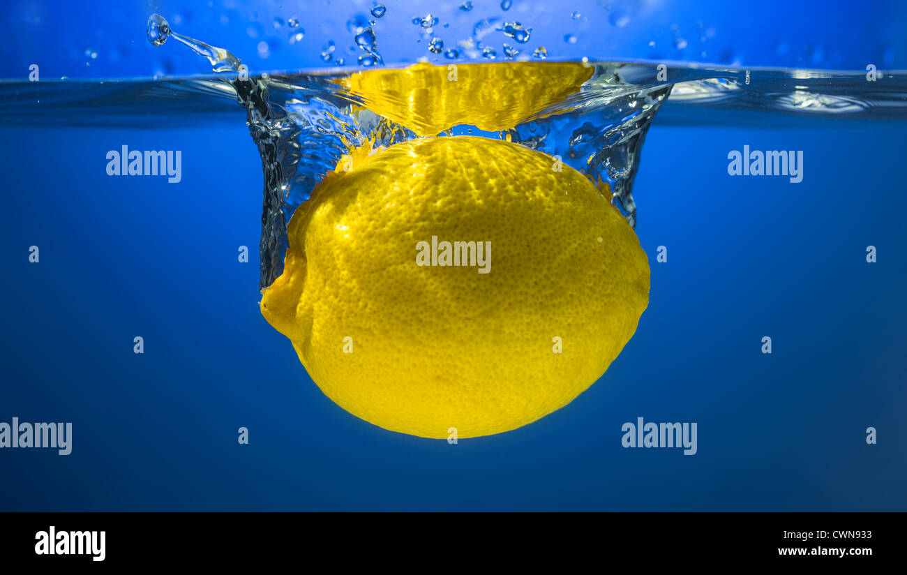 Yellow lemon in water splash Stock Photo - Alamy