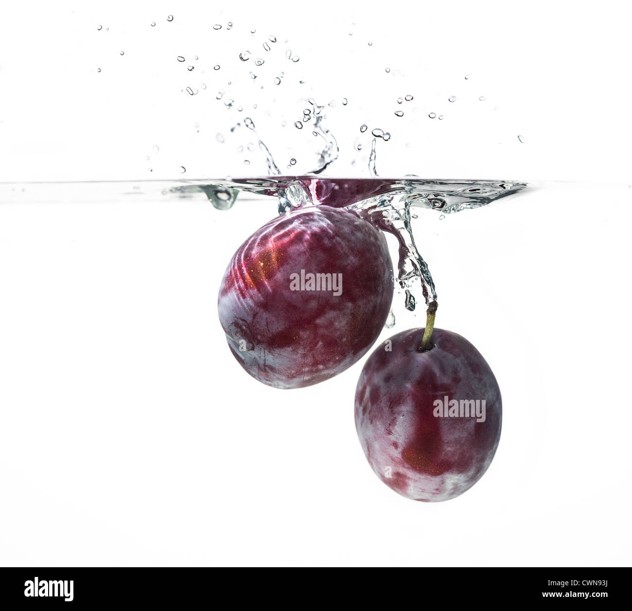 Fresh plums in water splash Stock Photo - Alamy
