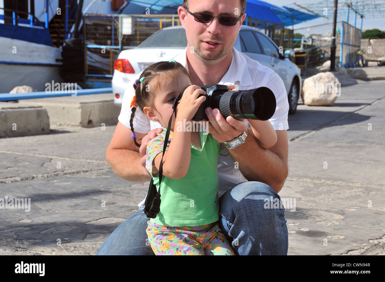 Dad teaches his daughter to photograph their camera, and maintains its ...