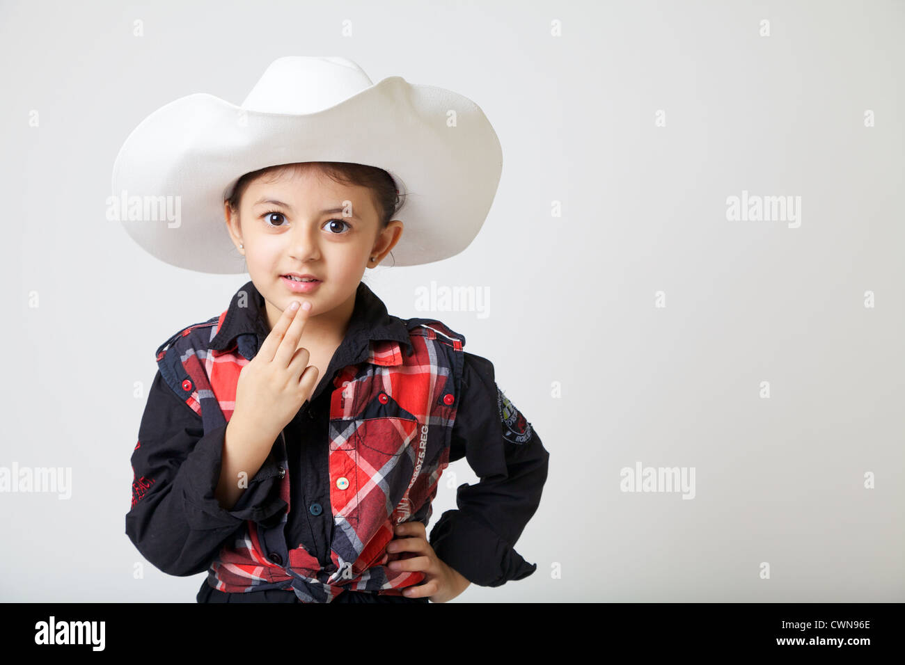 Young girl wearing a hat standing in a cowboy pose Stock Photo - Alamy