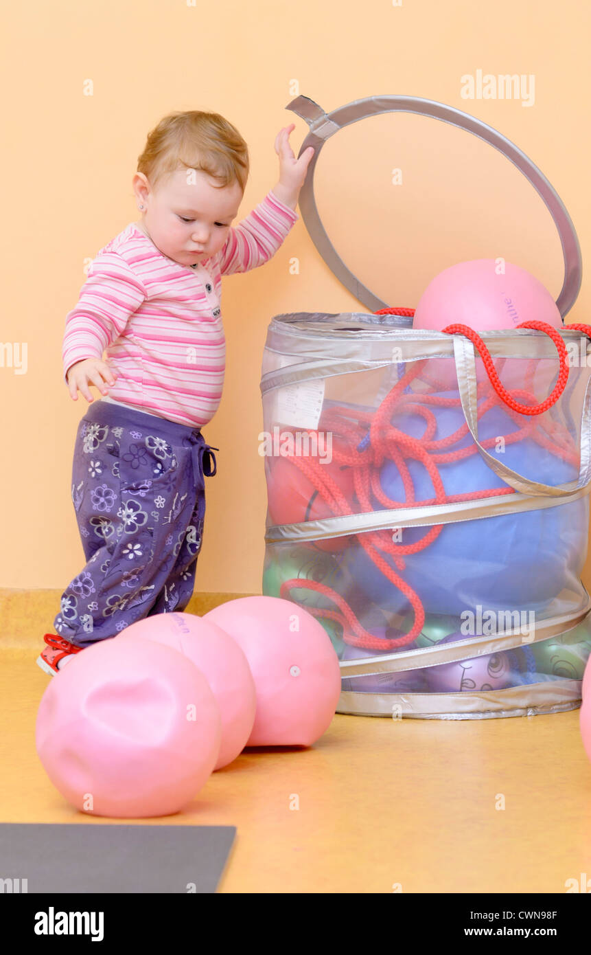 Little girl searching for toys Stock Photo - Alamy