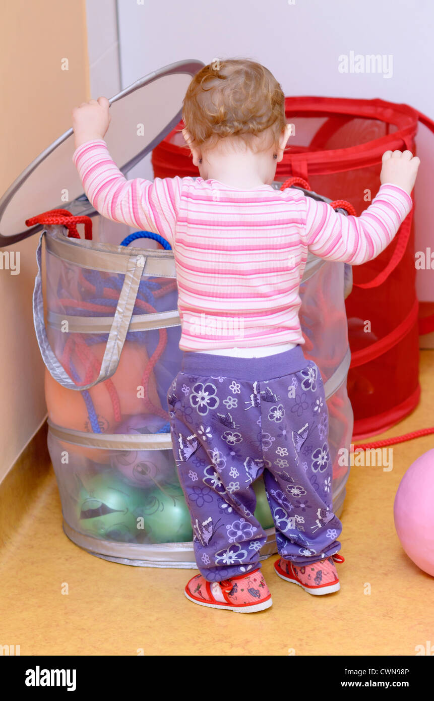 Little girl searching for toys Stock Photo - Alamy