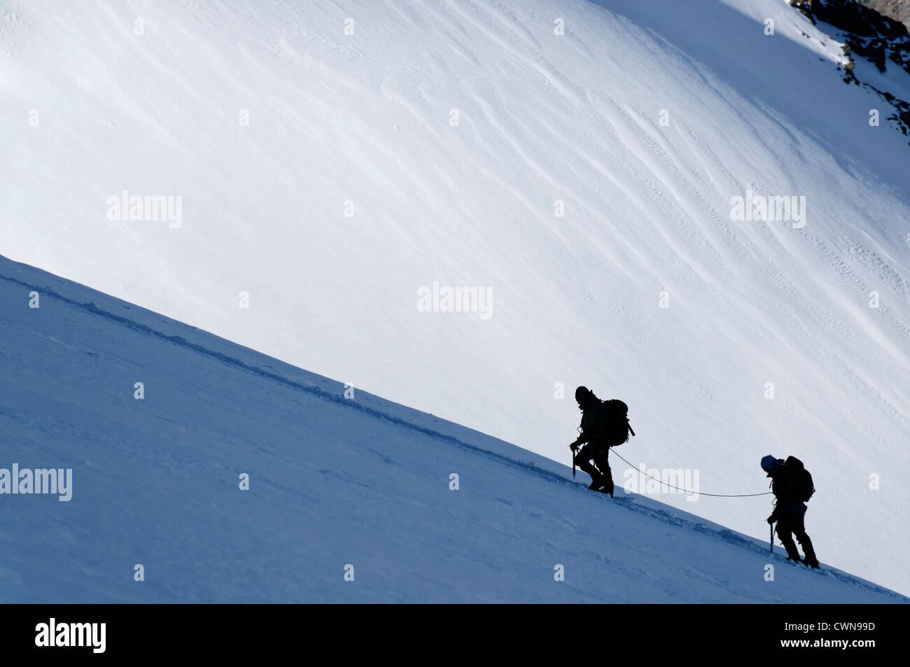A silhouette of climbers on a snowy ridge hi-res stock photography and ...