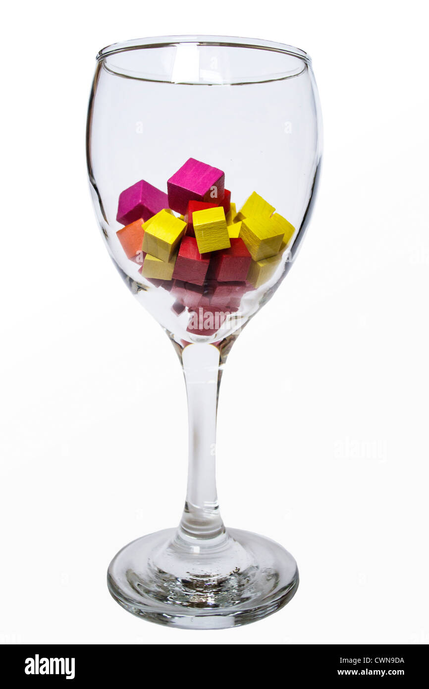 Healthy drink concept with a crystal glass filled with colored cubes ...