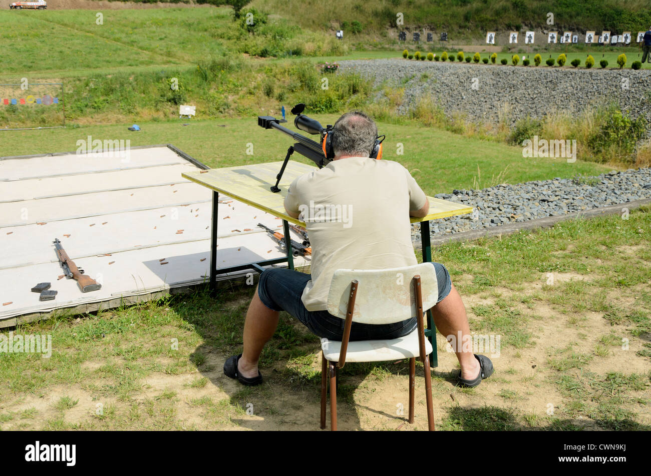 Man shooting rifle at range Stock Photo - Alamy