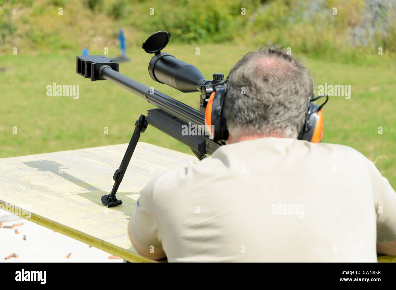 Man shooting rifle at range Stock Photo - Alamy