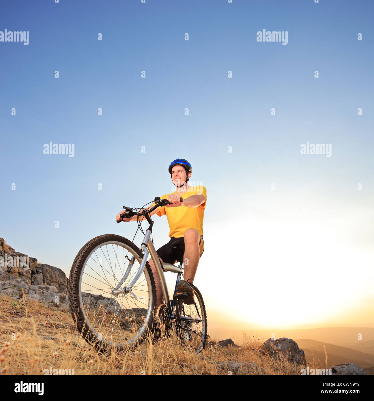 Person riding a mountain bike on a sunset Stock Photo - Alamy