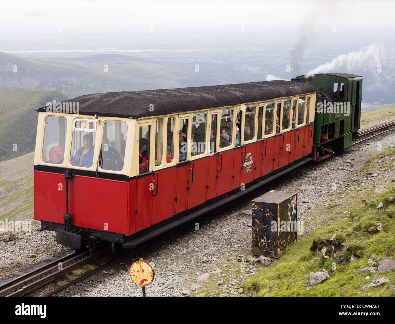 Mount Snowdon Mountain Railway train carriage pushed by steam engine Wyddfa carrying passengers ...