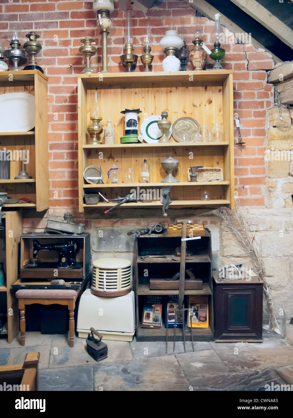 A corner of an antique shop with a collection of old country farm and ...