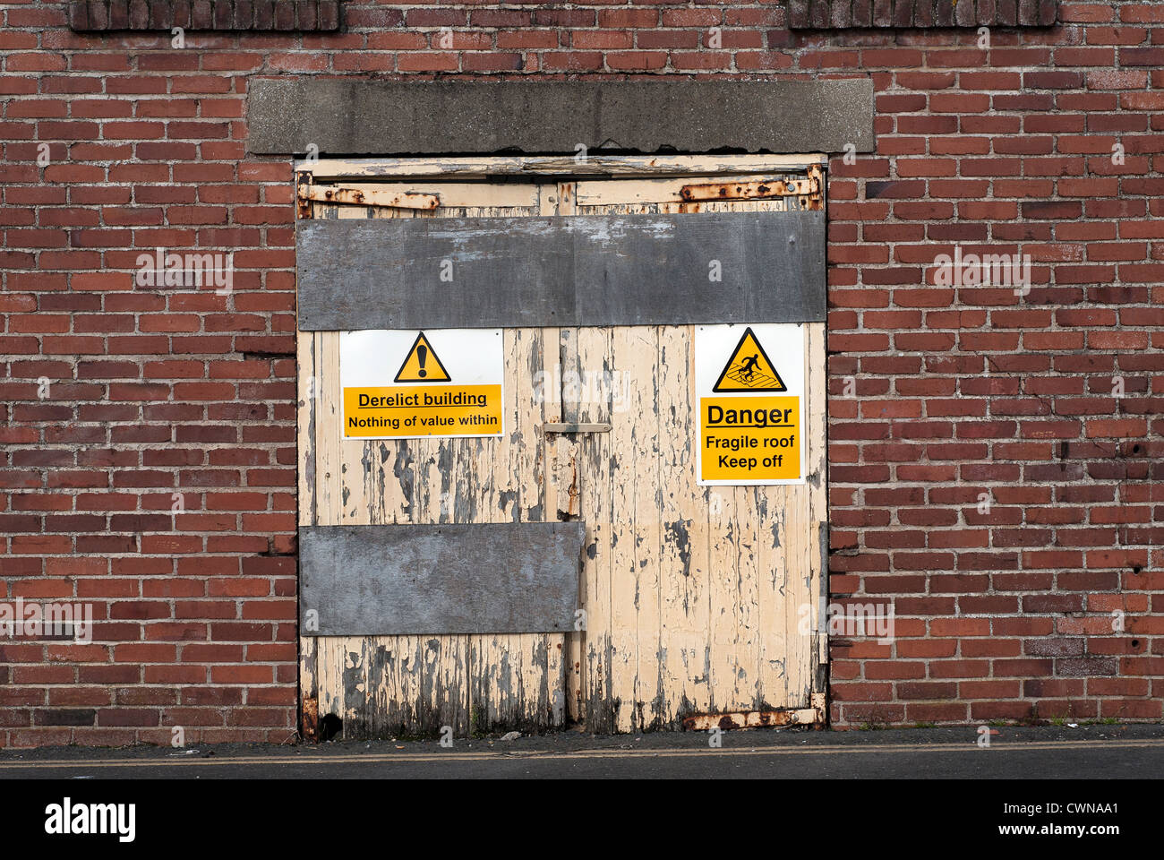 Derelict building,Danger fragile roof,double doors of industrial unit ...