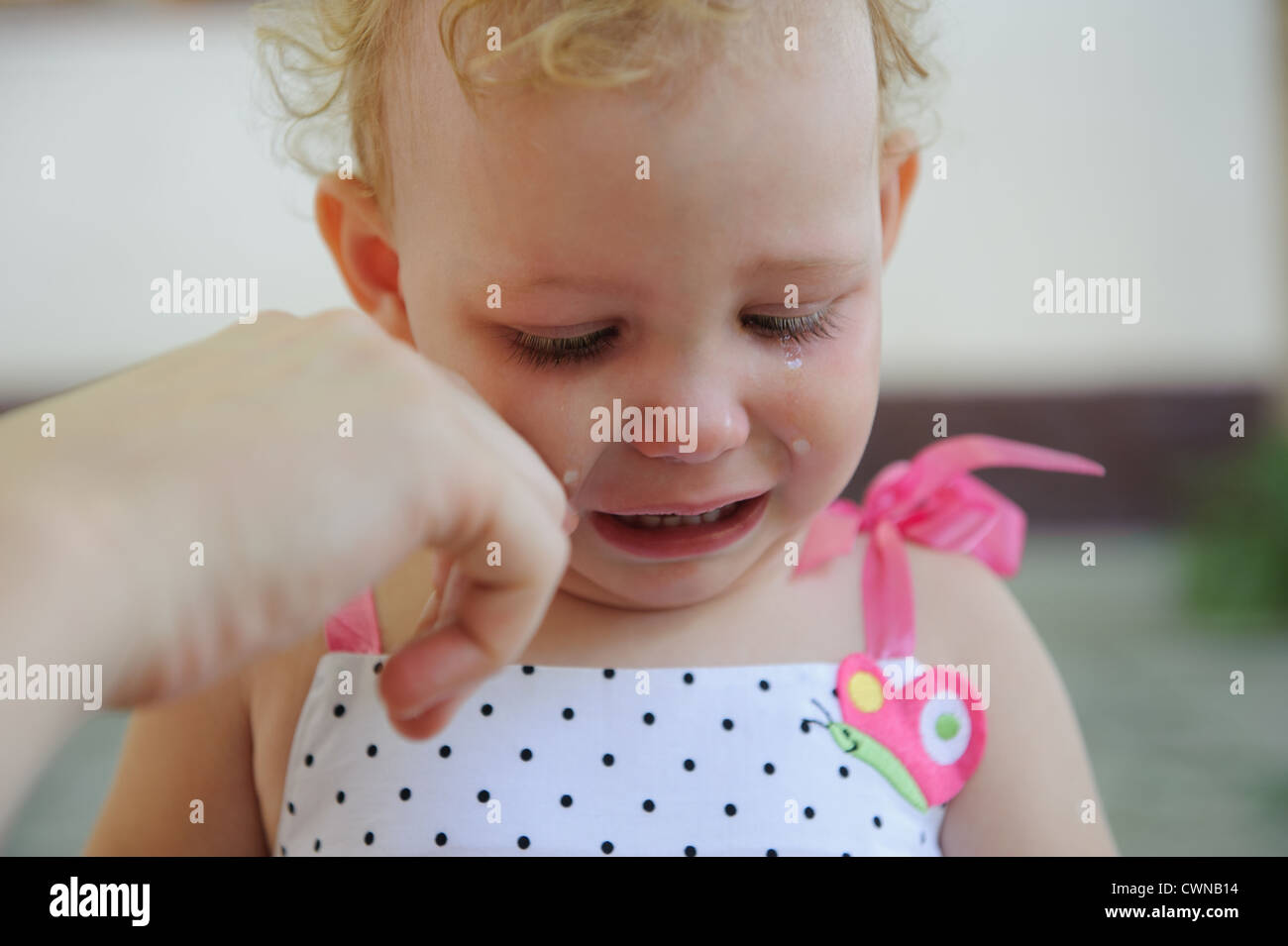 Little cute girl crying. Mother trying to console her Stock Photo - Alamy