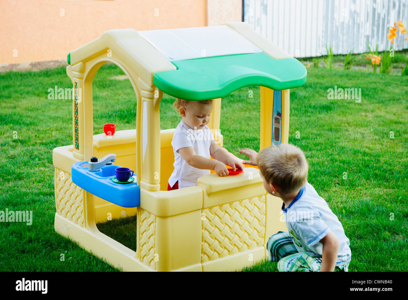 Children playing in toy house at playground Stock Photo - Alamy